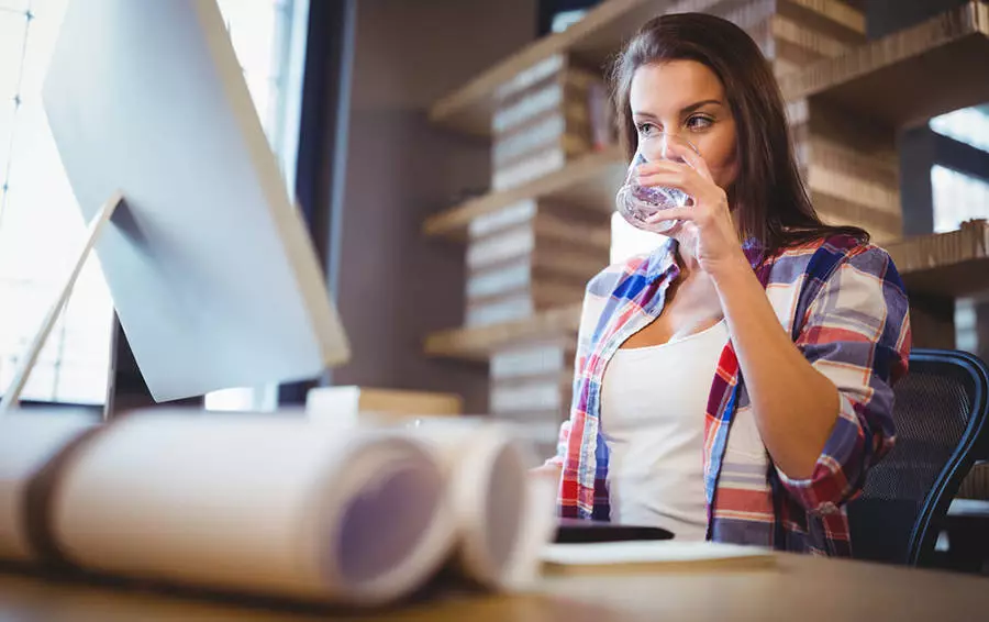 Girl drinks water at work